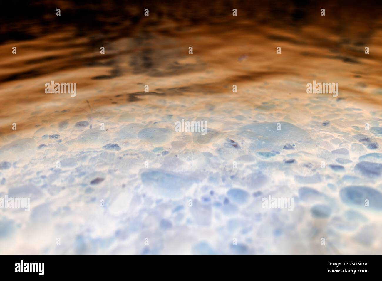 Abstract photo with color inversion of transparent water surface and ...