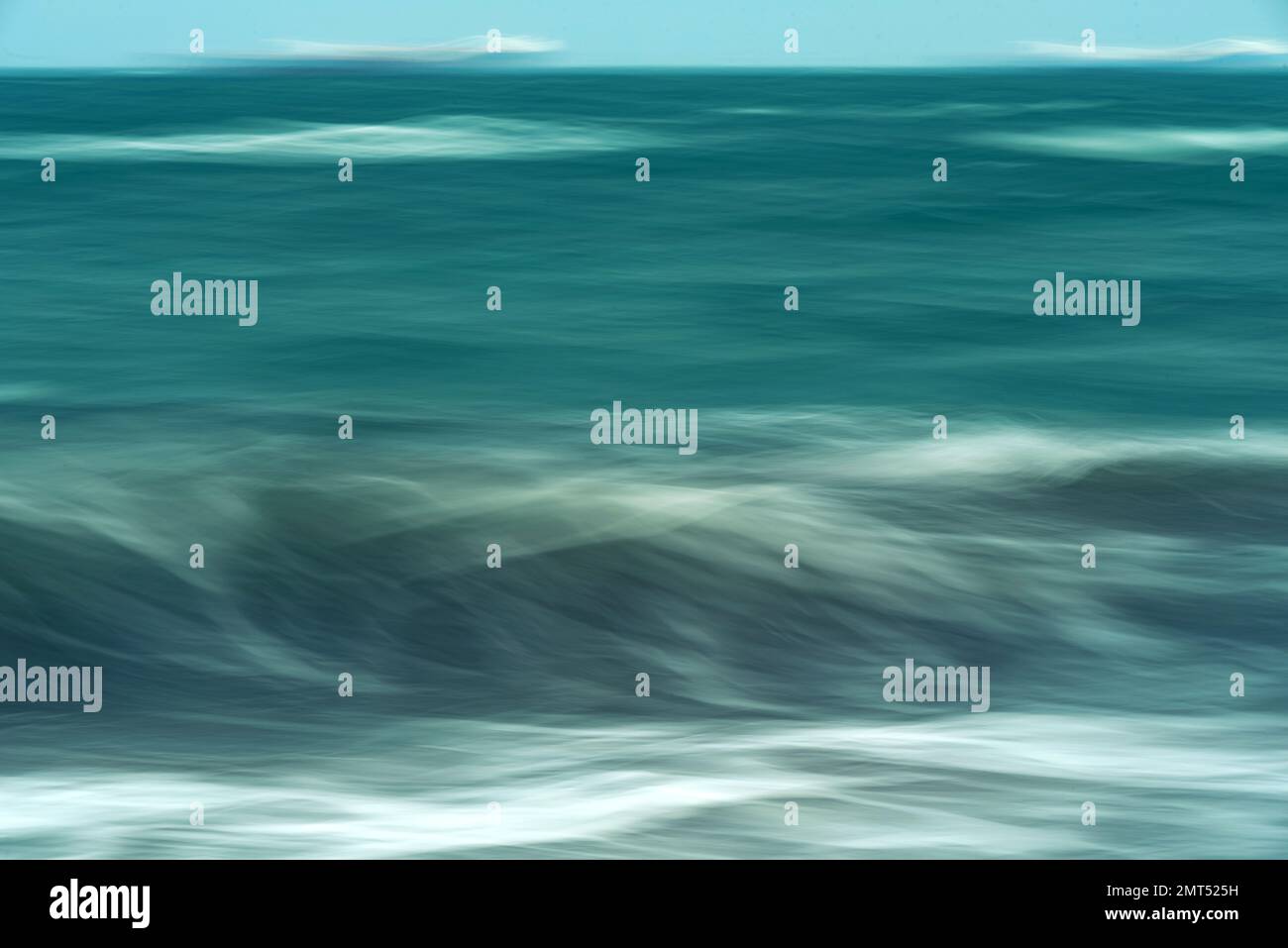 Abstract intentional camera movement of textured blurred aqua green ...