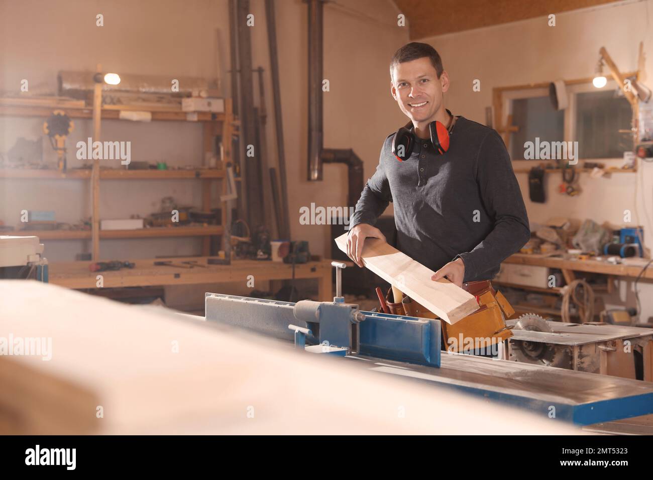 Professional carpenter working with surface planer in workshop Stock Photo - Alamy