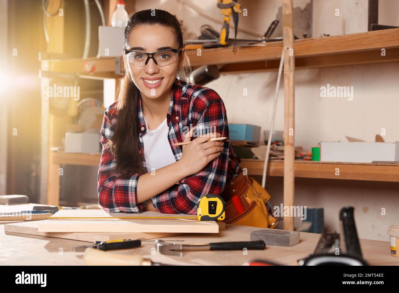 Female carpenter with wooden boards in workshop Stock Photo - Alamy