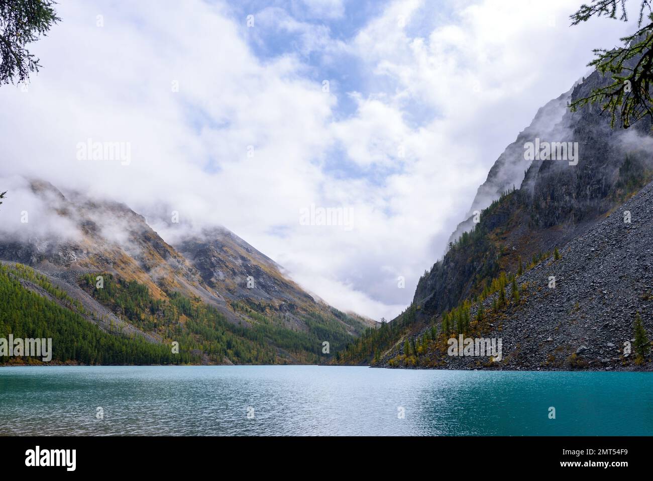 The fog leaves the mountains after the rain on Lake Shavlinskoye in ...