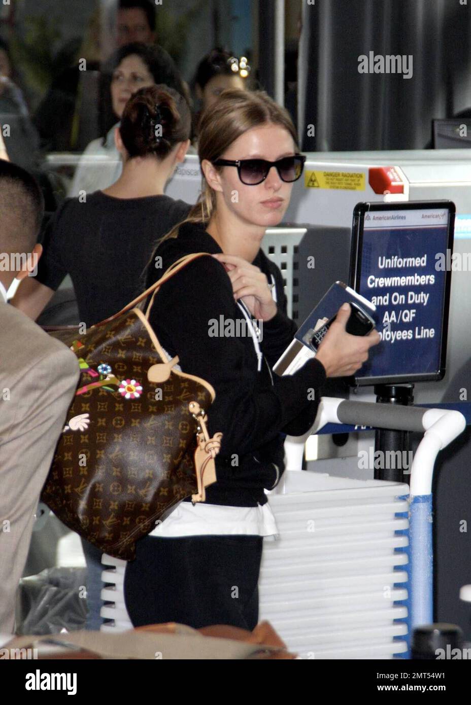 Nicky Hilton and boyfriend David Katzenberg head through the security ...