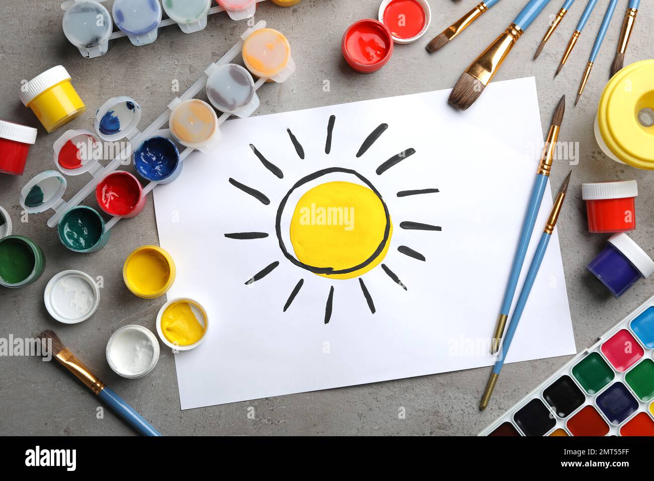 Flat lay composition with child's painting of sun on grey table Stock ...