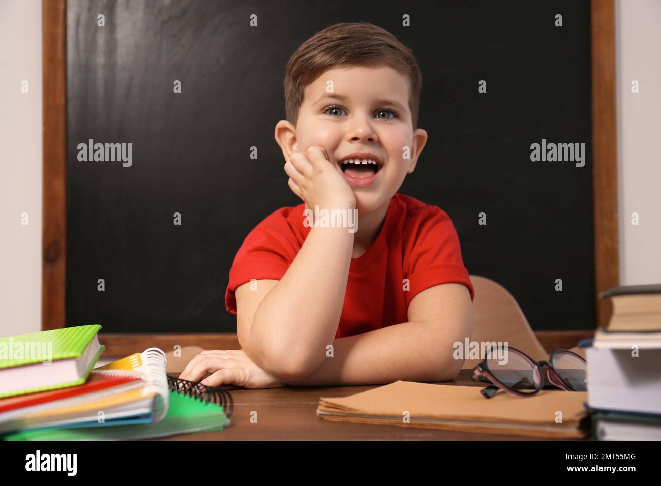 Cute little child at desk in classroom. First time at school Stock ...