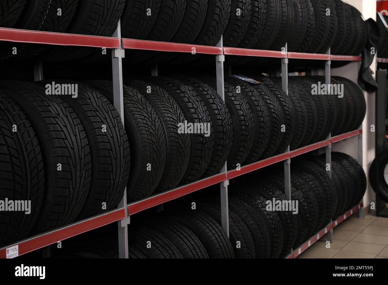 Car tires on rack in auto store Stock Photo - Alamy
