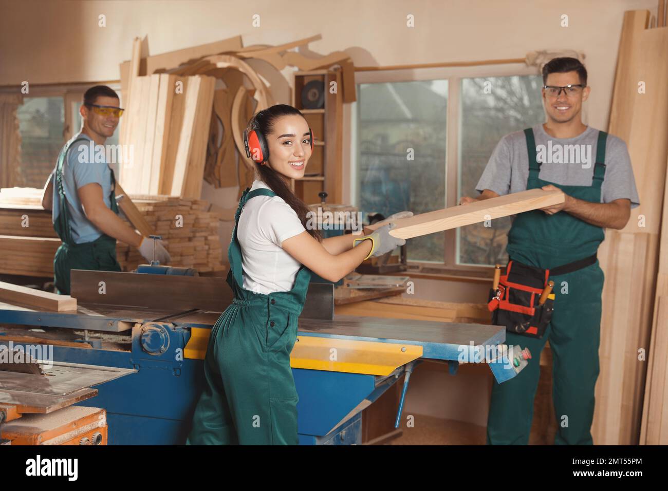 Professional carpenters with wooden plank in workshop Stock Photo - Alamy