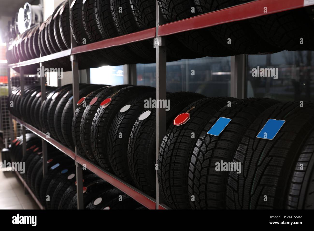 Car tires on rack in auto store Stock Photo - Alamy