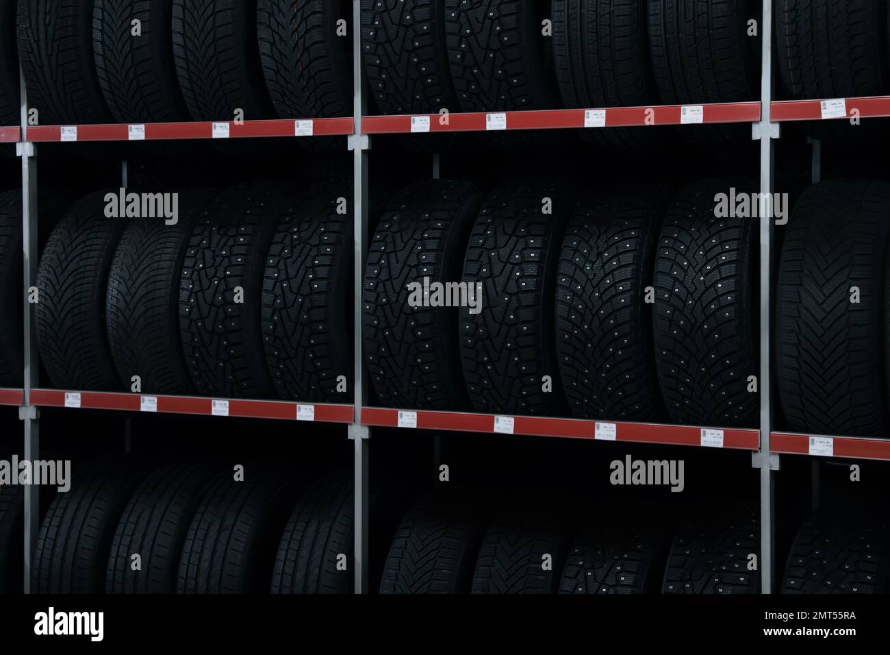 Car tires on rack in auto store Stock Photo - Alamy