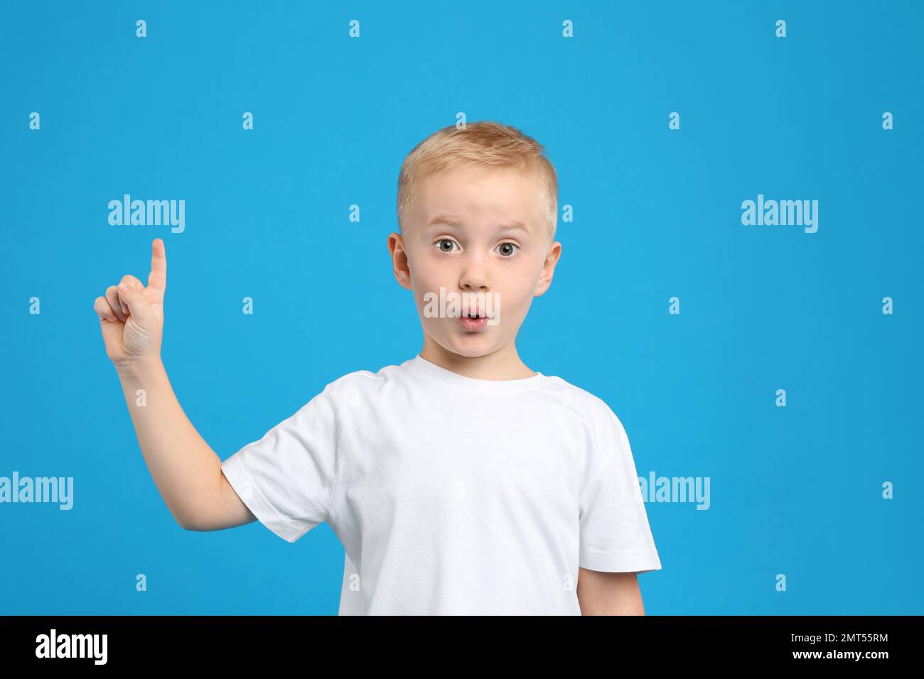 Portrait of cute little boy on light blue background Stock Photo - Alamy