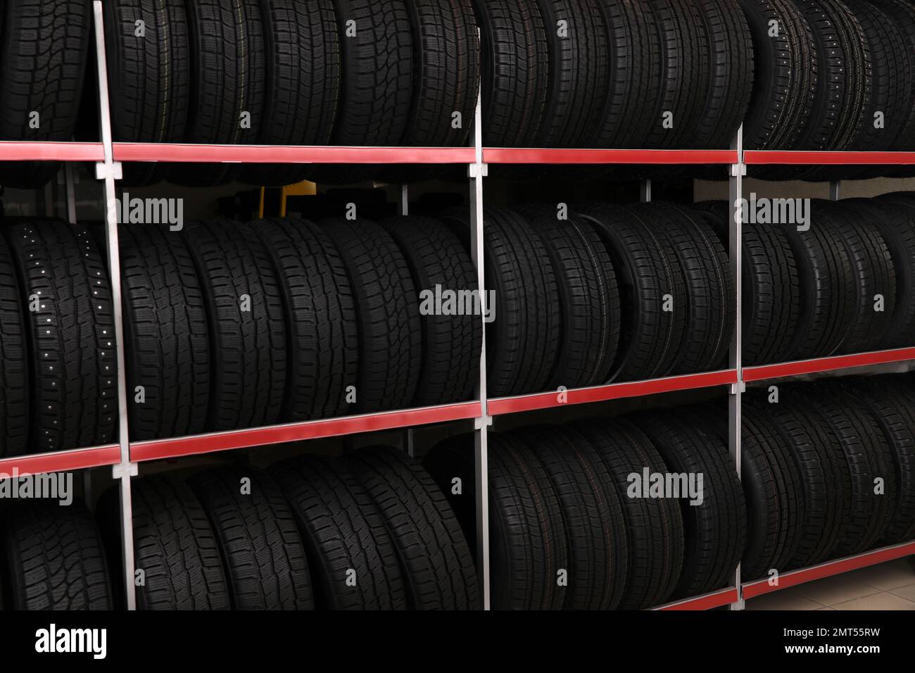 Car tires on rack in auto store Stock Photo - Alamy