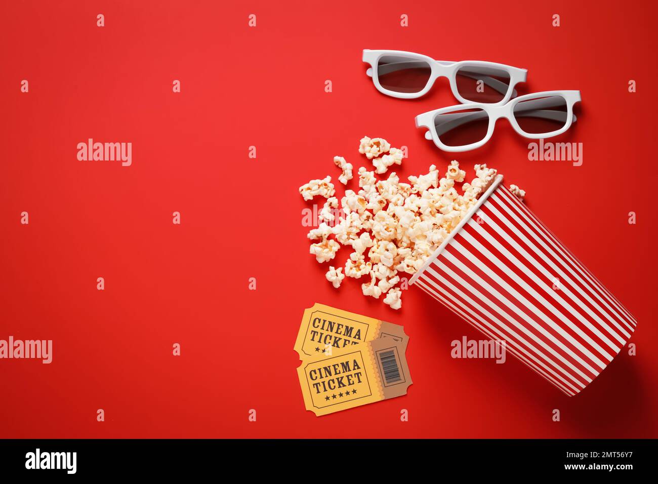 Overturned paper cup with delicious popcorn, cinema tickets and 3D ...