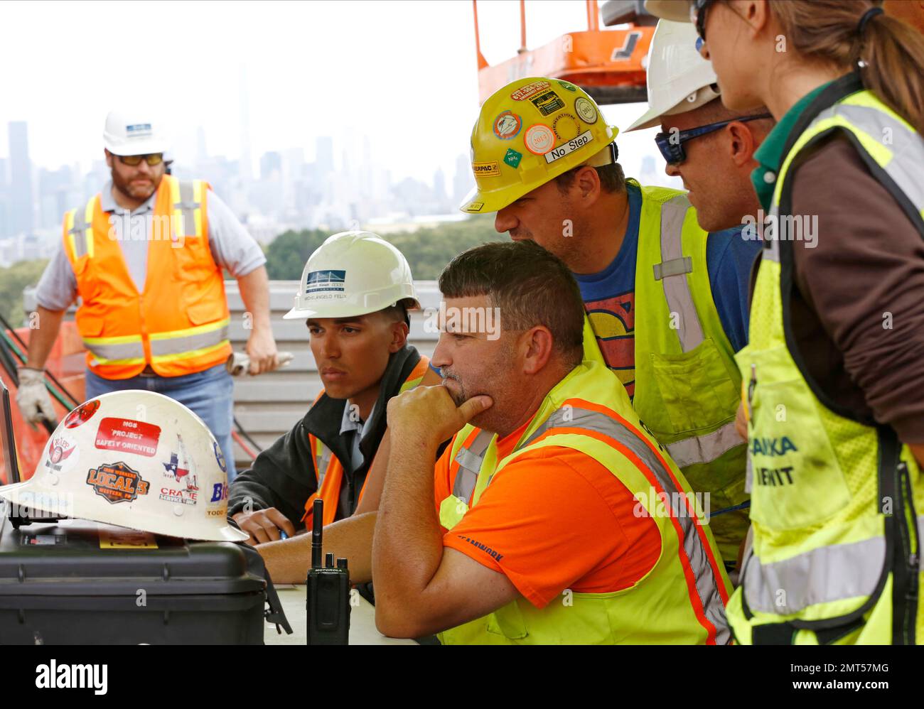A team of engineers controlling a computerized lowering system from a ...
