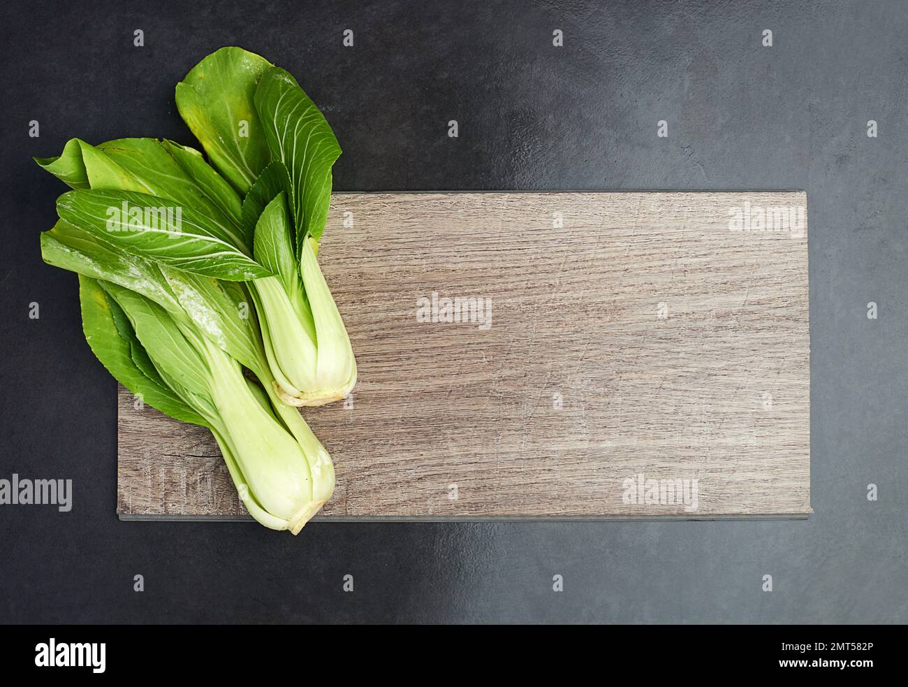 Bok choy joy. Top view of leaves of chinese cabbage lying on a chopping ...