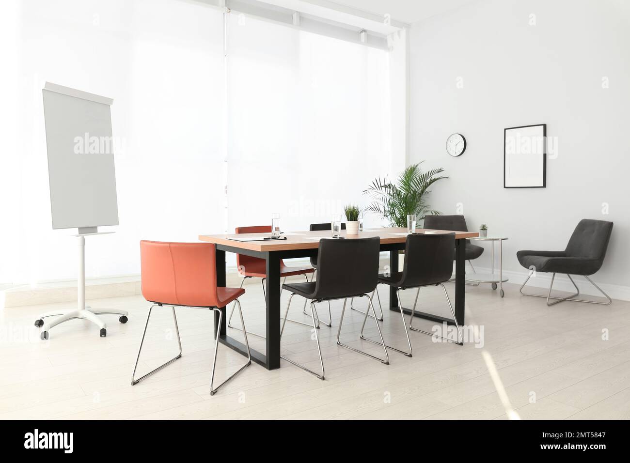 Simple office interior with large table and chairs Stock Photo - Alamy