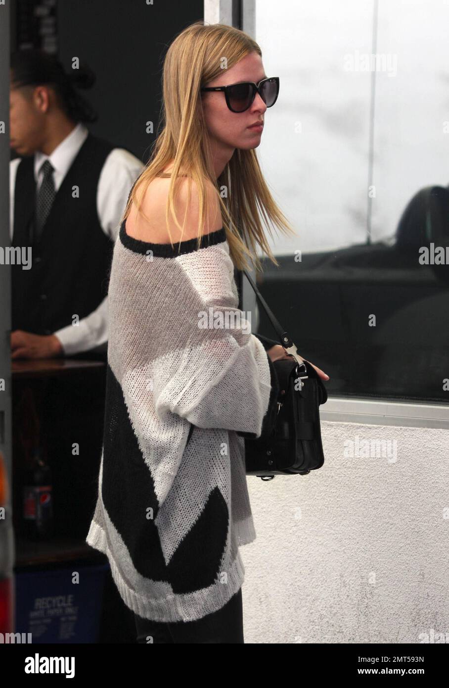Nicky Hilton wears an oversized sweater, black leggings and boots as ...