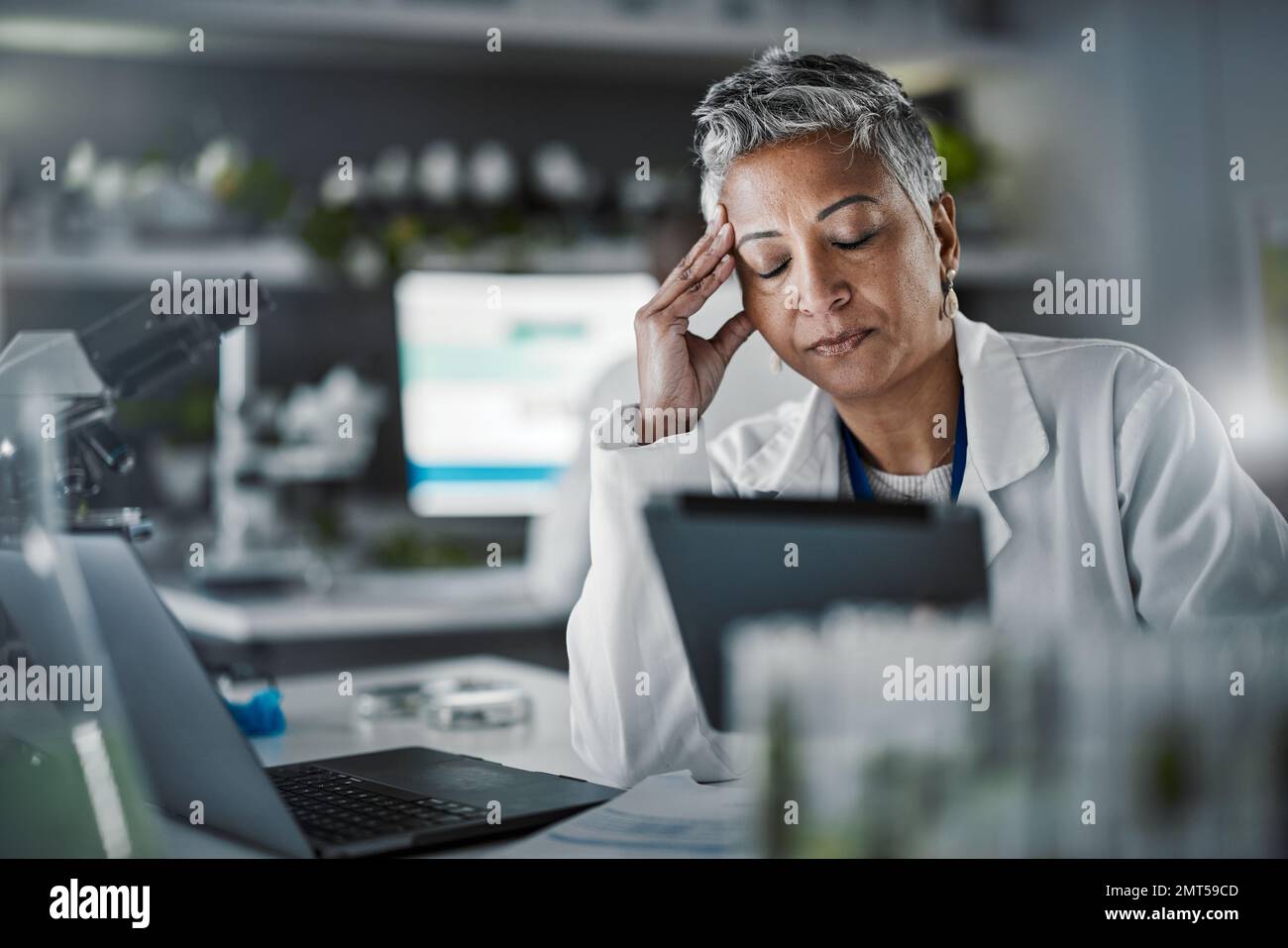 Headache, tired and scientist woman in laboratory working on tablet for ...