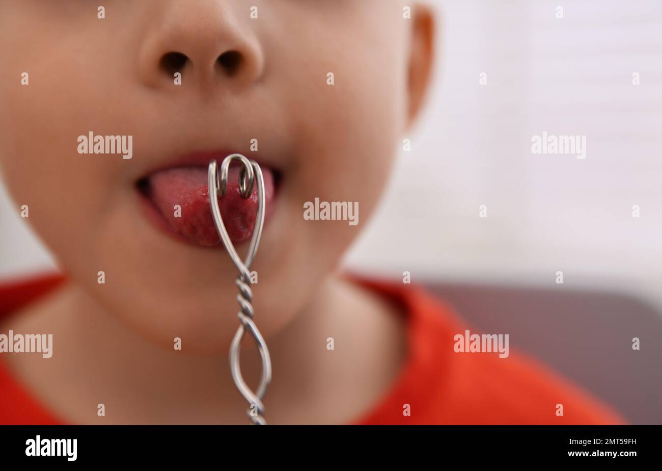 Little boy doing exercise with logopedic probe at speech therapist ...