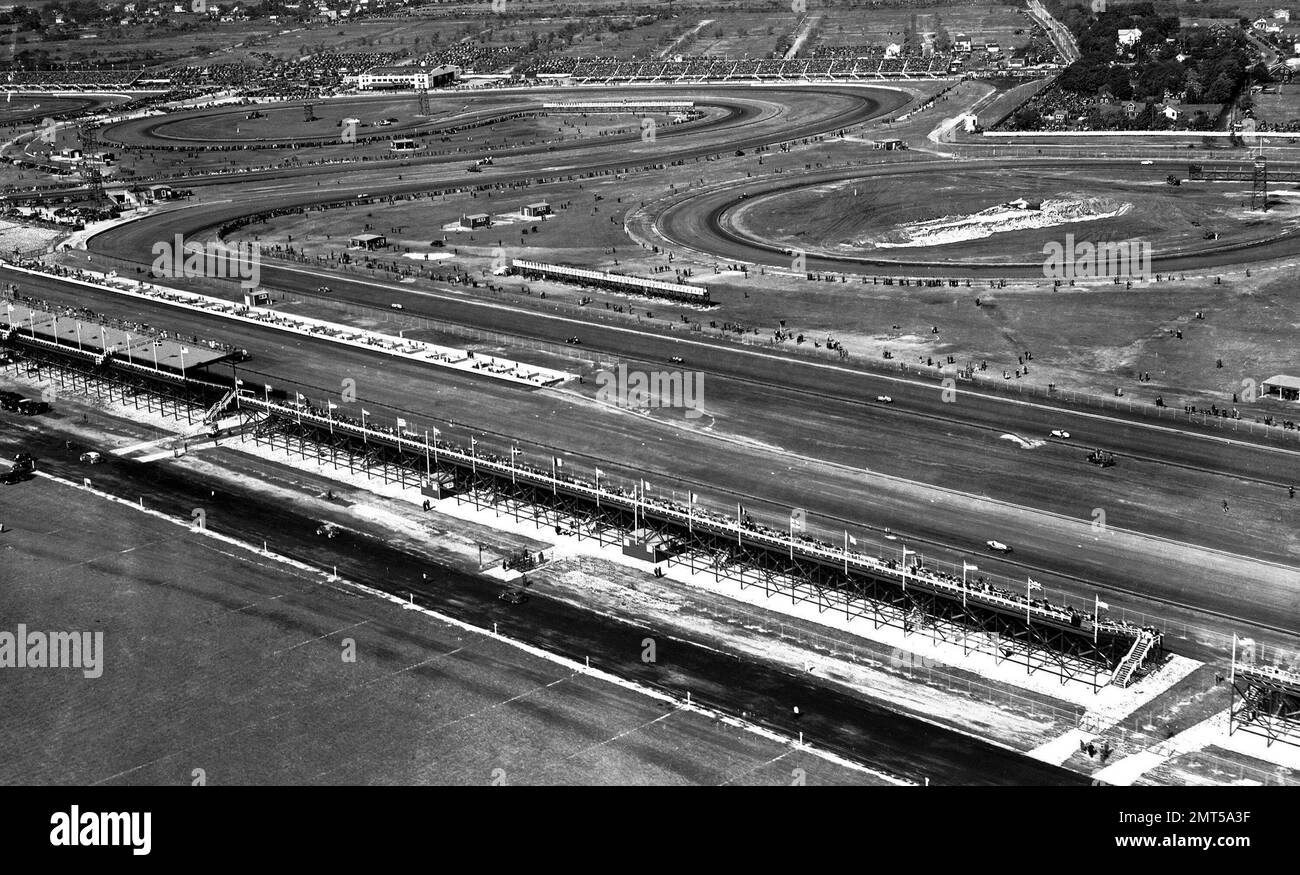 Cars speed around the four-mile dirt track during the 300-mile ...