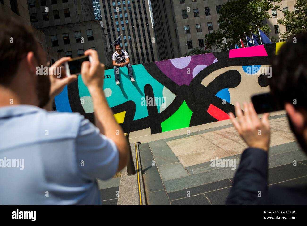 On Tuesday, July 18, 2017, passerbys take photos of artist, JM Rizzi a ...