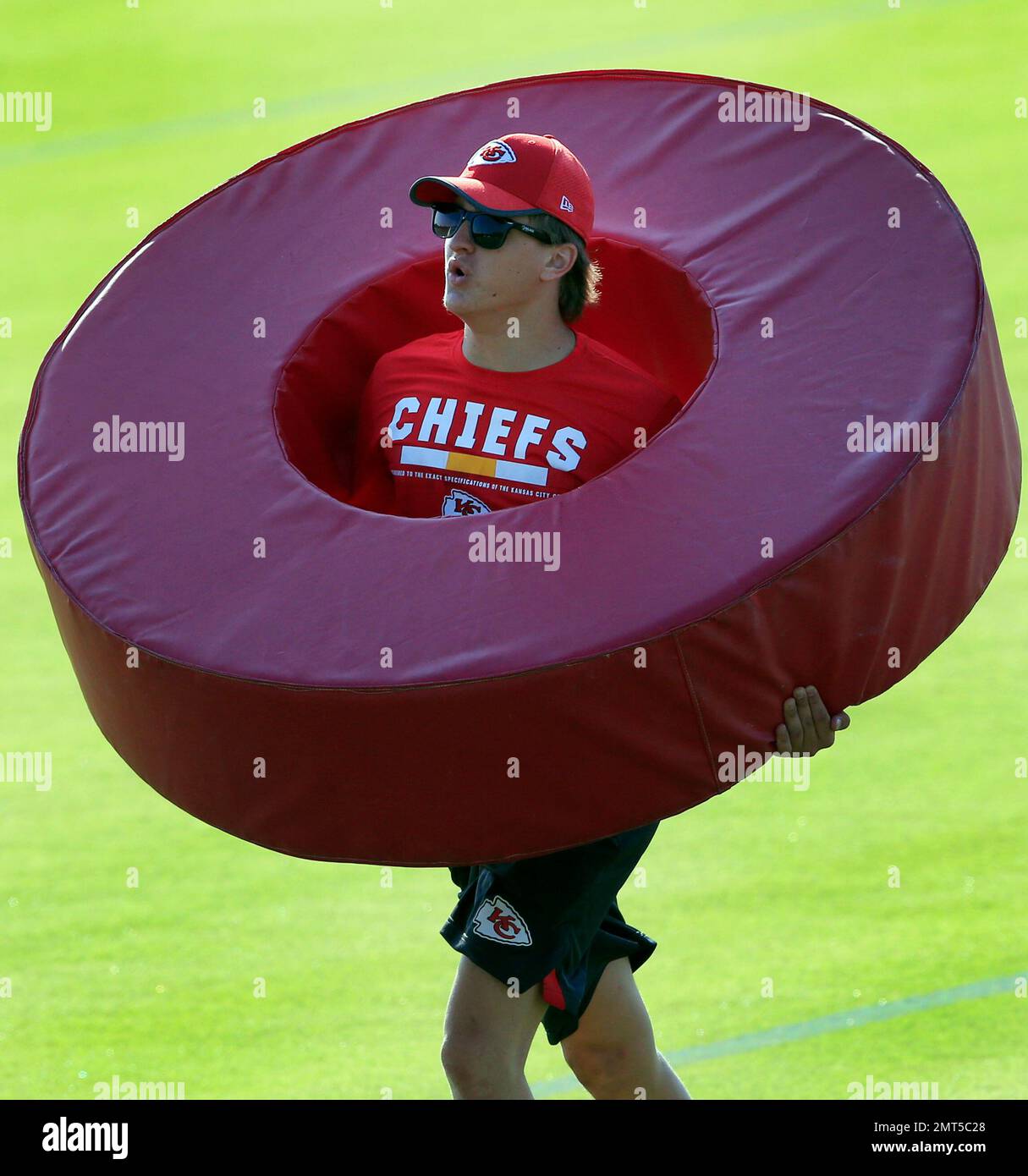 A Kansas City Chiefs training crew member moves equipment during NFL ...