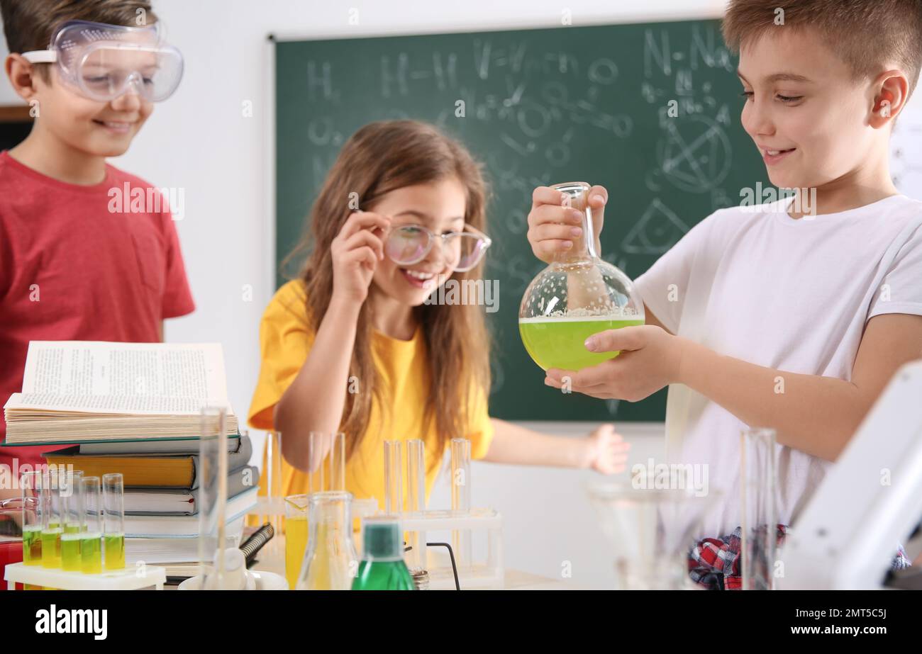 Smart pupils making experiment in chemistry class Stock Photo - Alamy