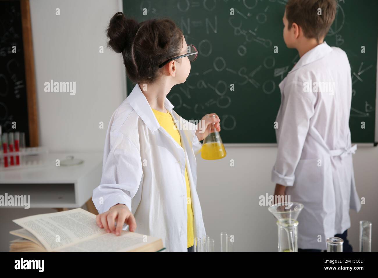 Smart pupils making experiment in chemistry class Stock Photo - Alamy