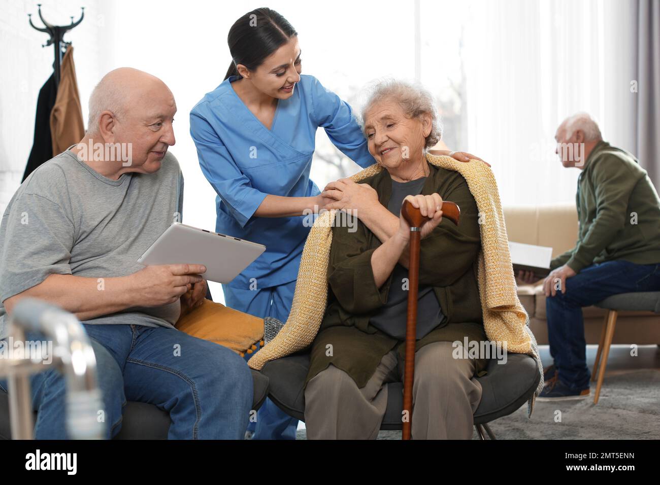Nurse taking care of elderly patients in geriatric hospice Stock Photo ...