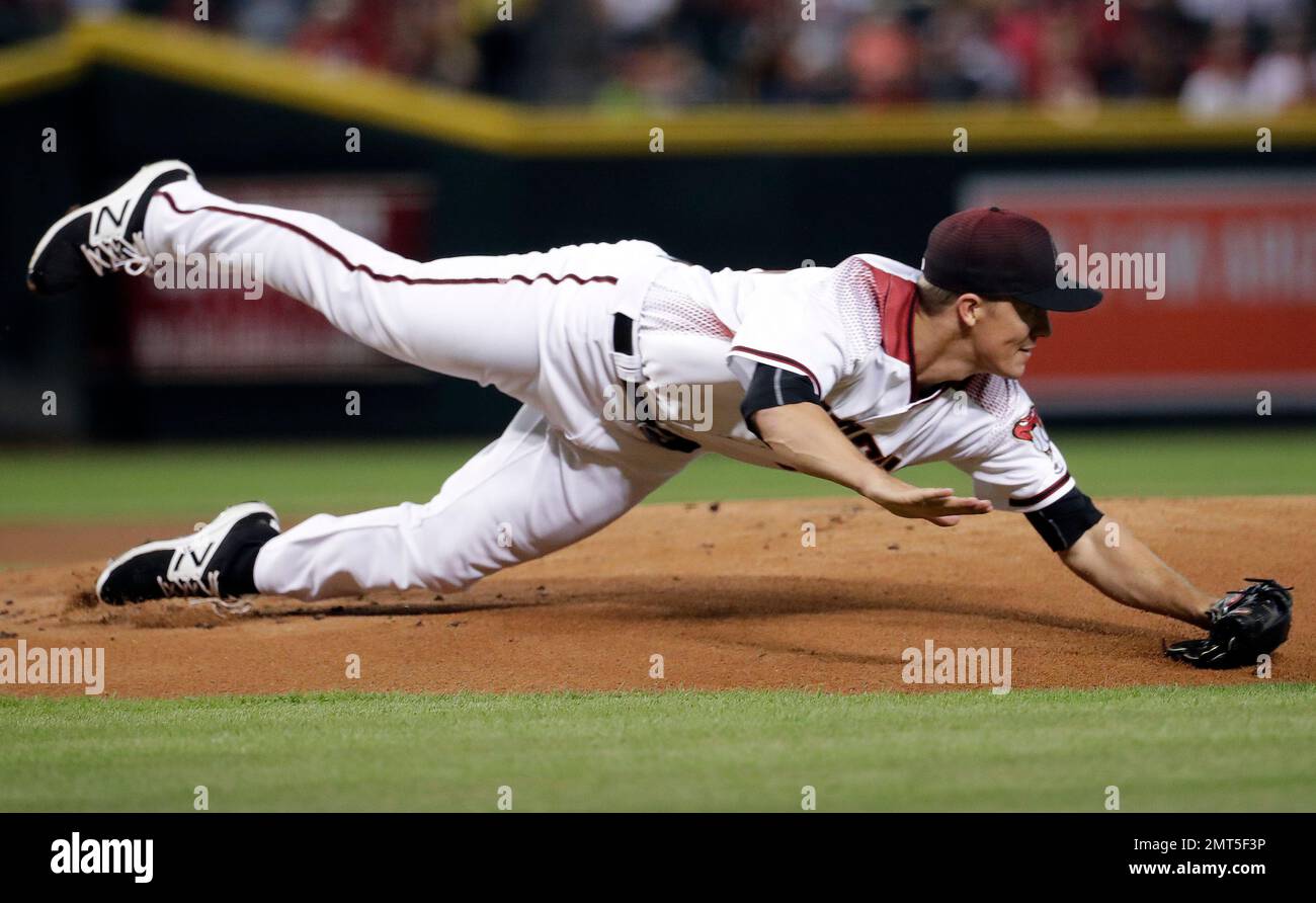 Arizona Diamondbacks starting pitcher Zack Greinke dives for a ground out hit by Atlanta Braves ...