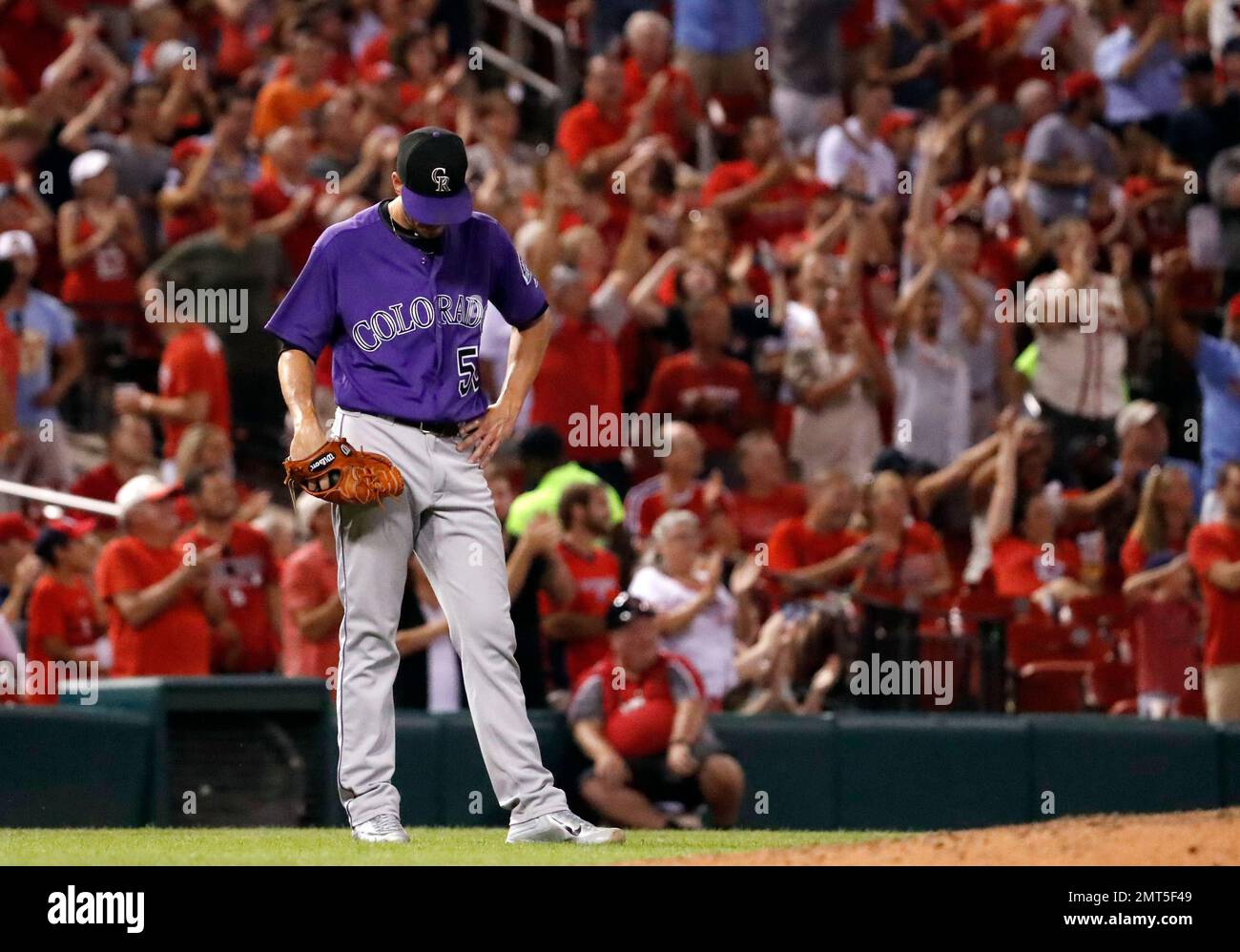 Colorado Rockies relief pitcher Chris Rusin pauses after giving up a ...