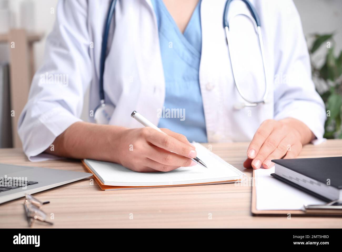 Doctor working at desk in office, closeup. Medical service Stock Photo ...
