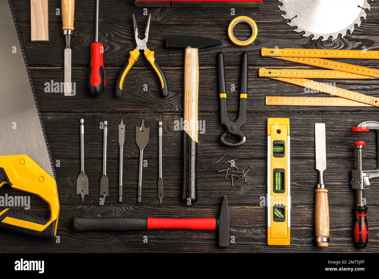Flat lay composition with carpenter's tools on black wooden background Stock Photo - Alamy