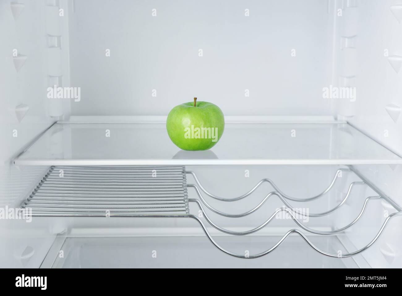 Fresh green apple on empty shelf in refrigerator Stock Photo - Alamy
