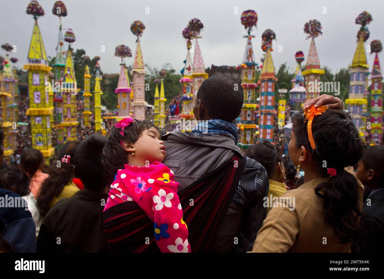 An Indian Pnar or Jaintia tribesman holds his sleeping child during ...