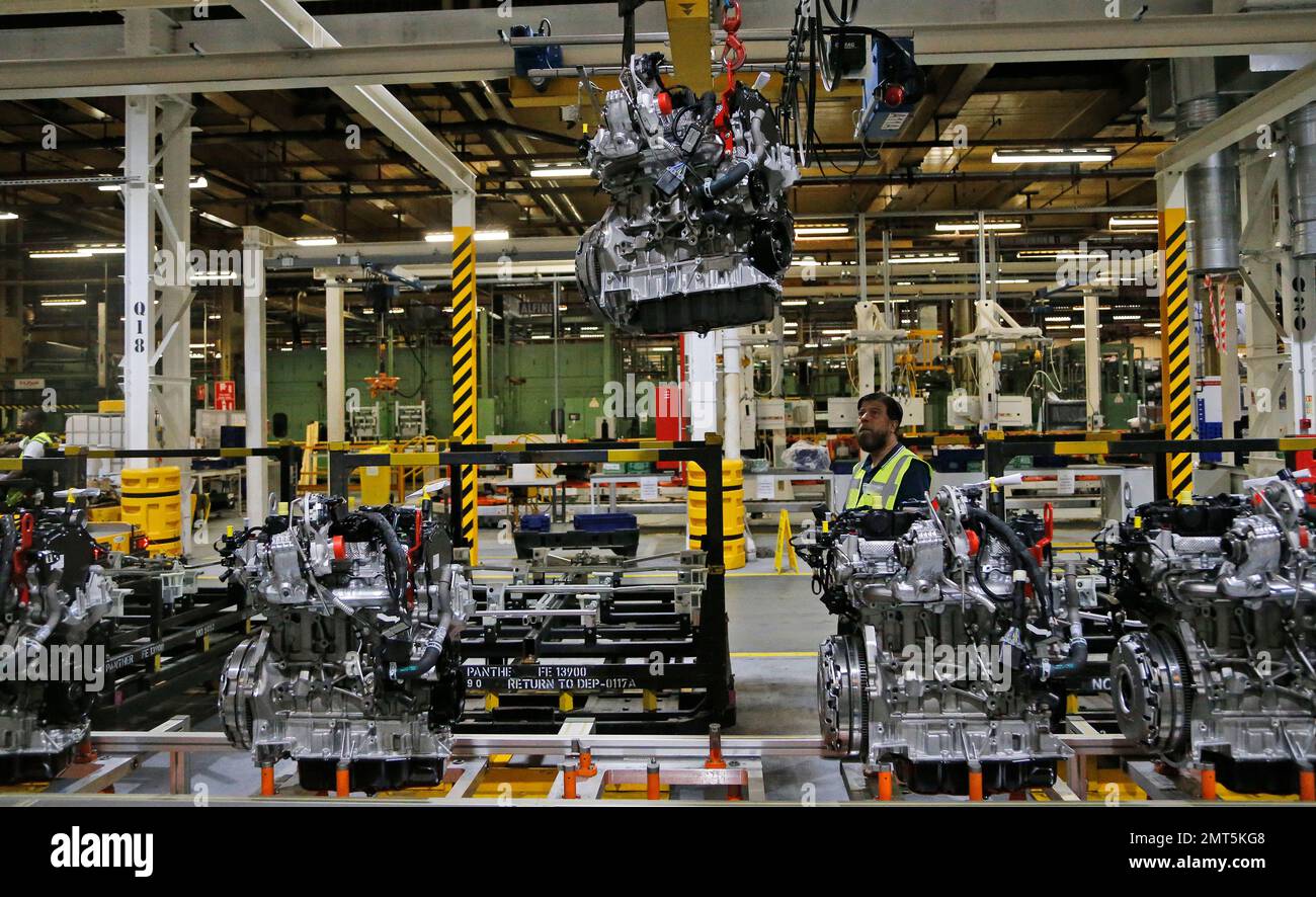 A Ford employee lifts two liter diesel engines, called panther engine ...