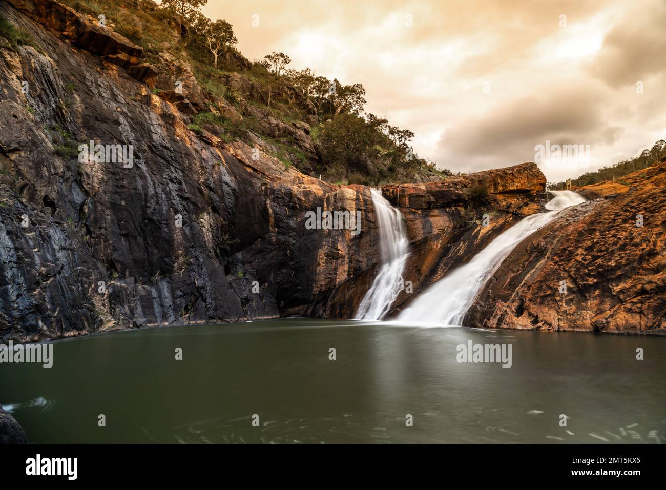 A view of the water fall on the lake under the cloudy sky Stock Photo ...