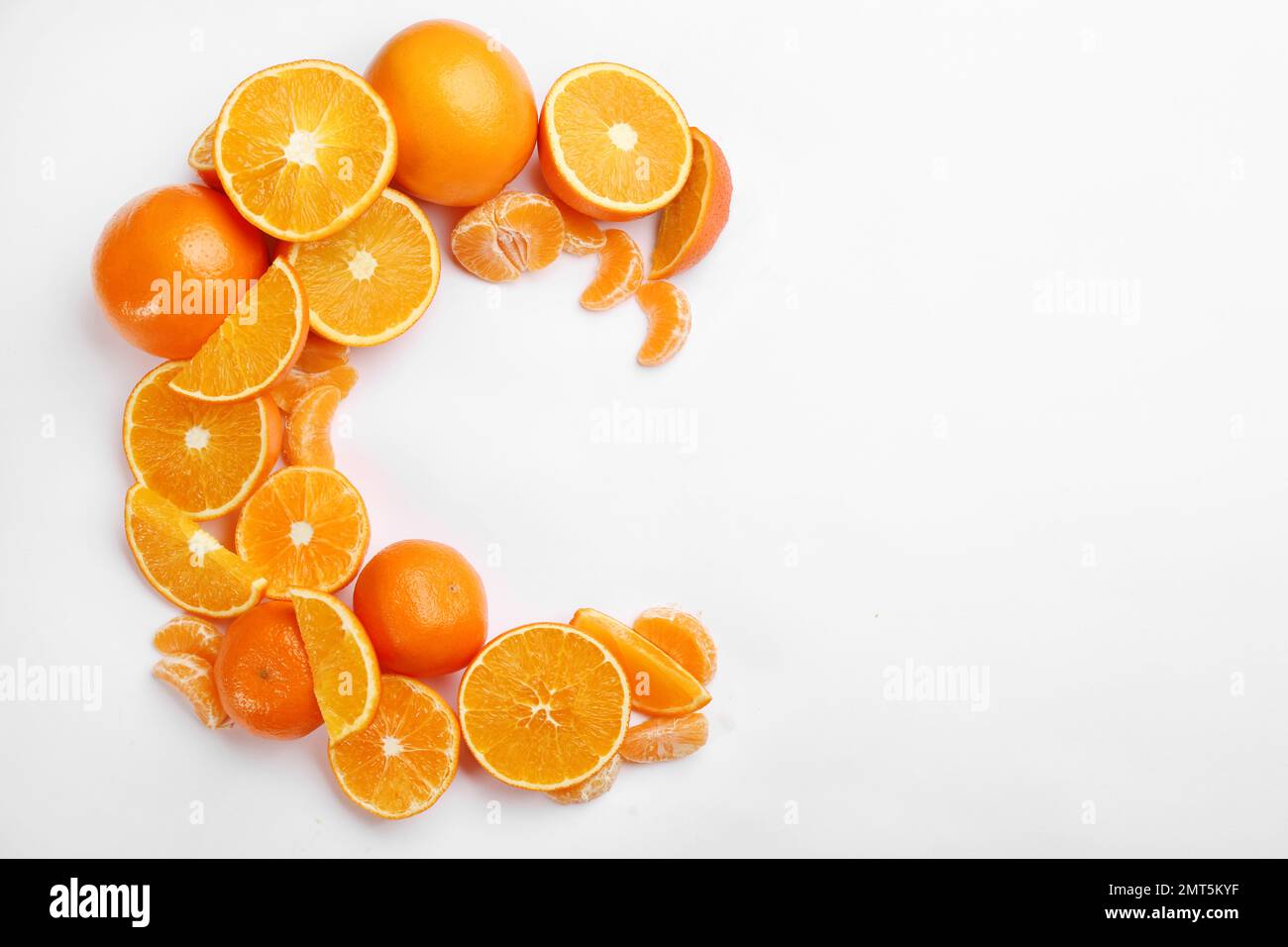 Letter C made with citrus fruits on white background as vitamin ...
