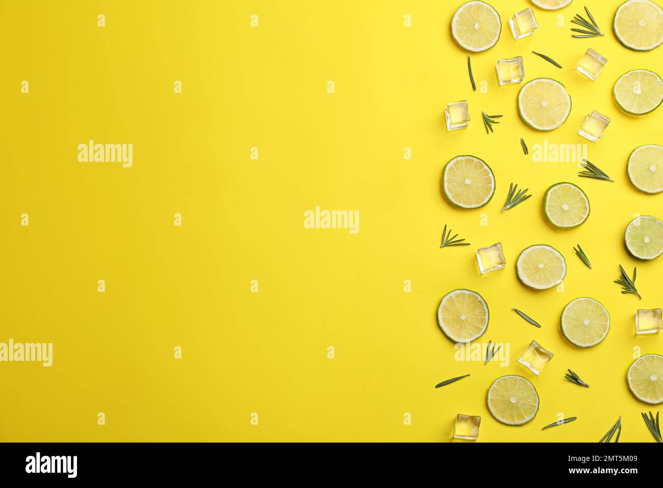Lemonade layout with juicy lime slices, rosemary and ice cubes on ...
