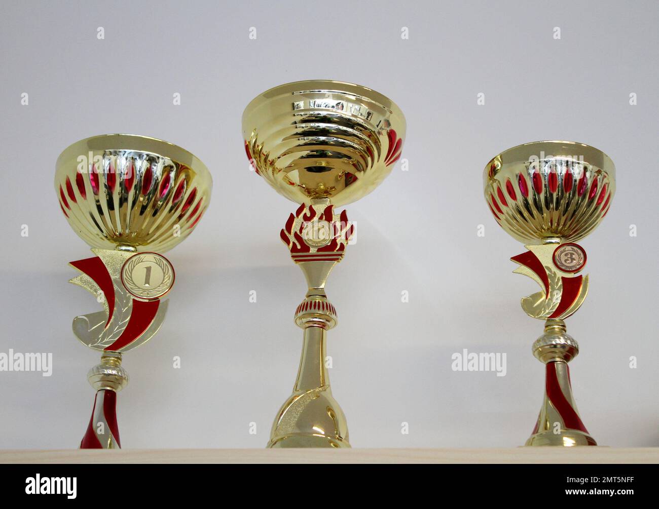 Sports cups for first and third place for winners Stock Photo - Alamy