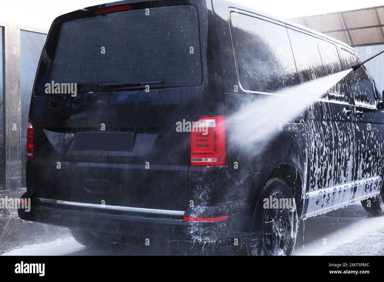Cleaning automobile with high pressure water jet at car wash Stock ...