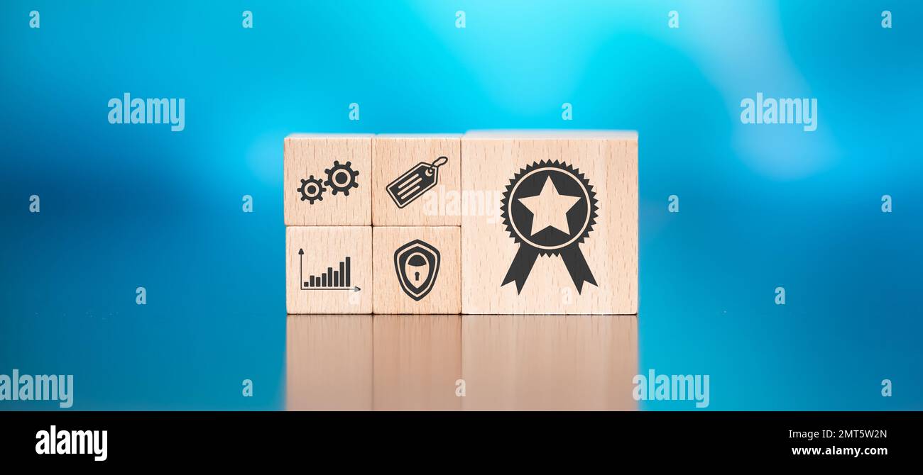 Wooden blocks with symbol of quality concept on blue background Stock ...