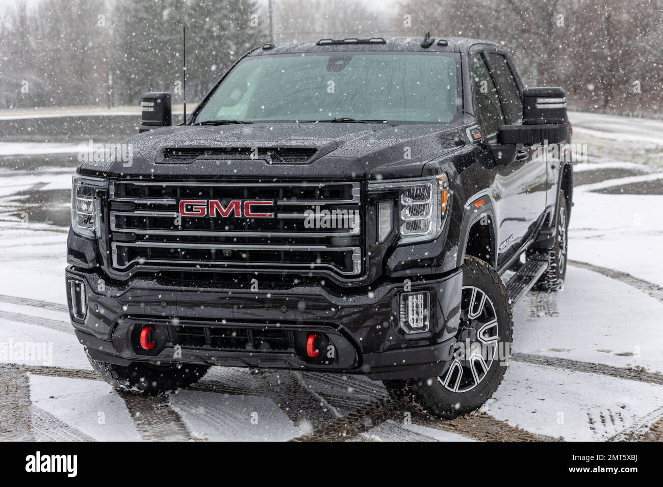 A Black Duramax 2020 GMC Sierra 2500HD AT4 pickup truck in the snow ...