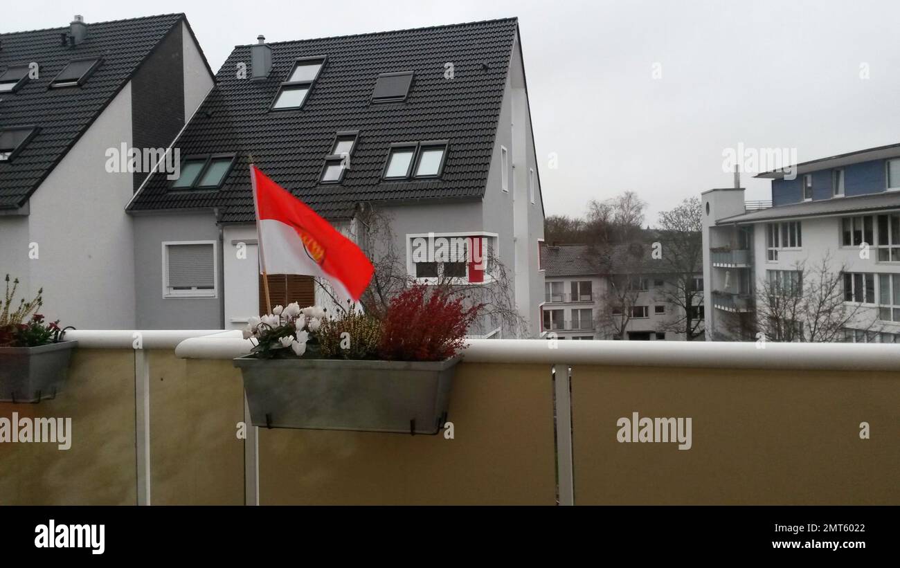 Flag with the Cologne city coat of arms flies on a balcony in winter ...