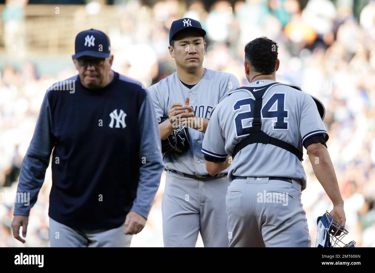 New York Yankees starting pitcher Masahiro Tanaka, center, stands on the mound after a ...