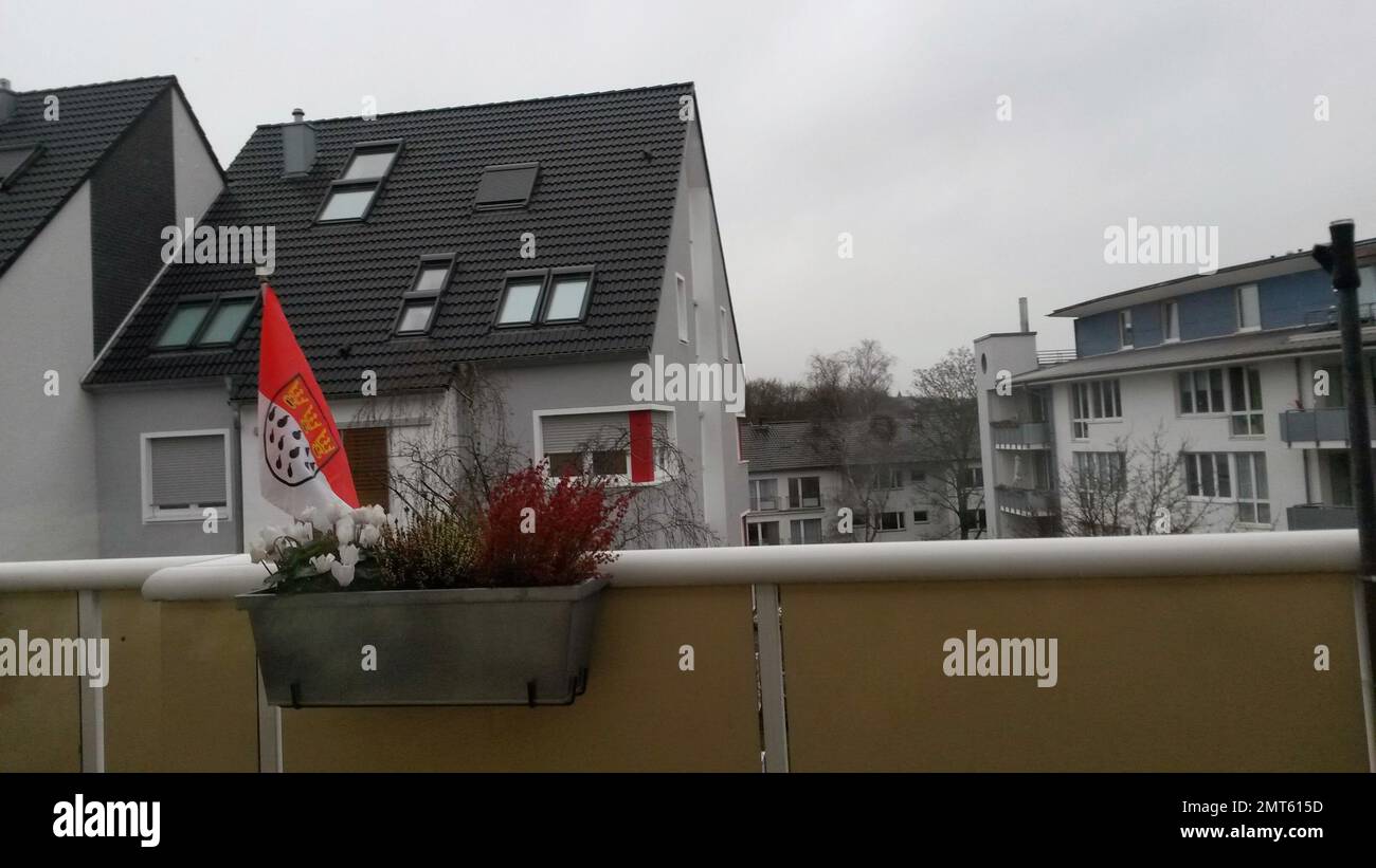 Flag with the Cologne city coat of arms flies on a balcony in winter ...