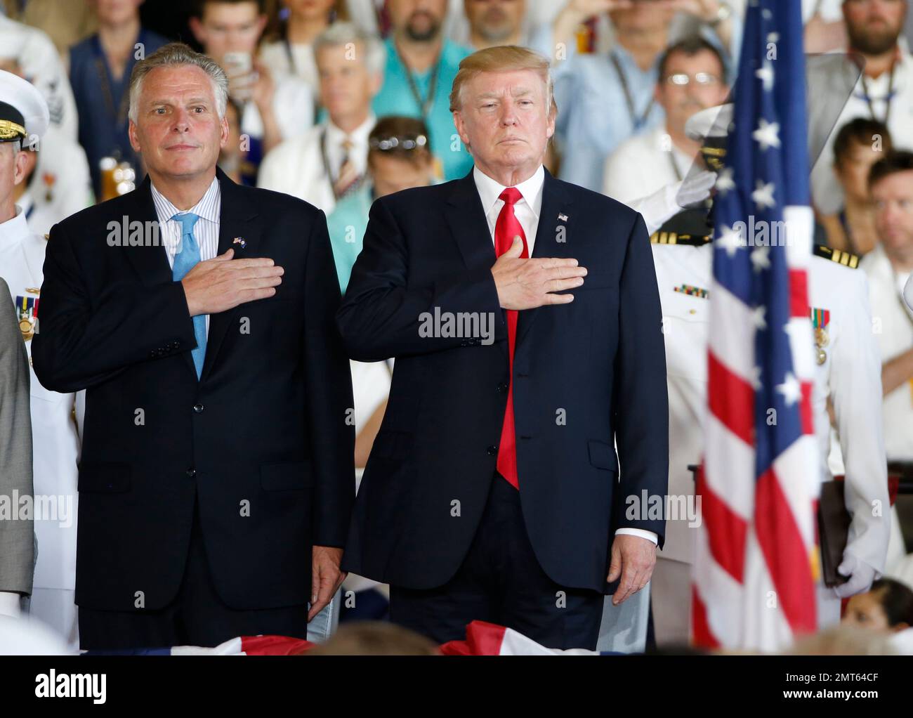 President Donald Trump, right, puts his hand over his heart with ...