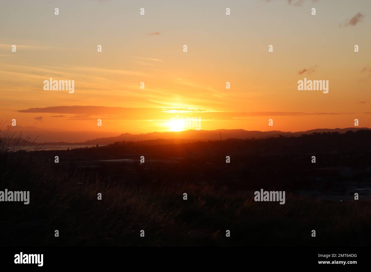 Sunsets over Auckland Stock Photo - Alamy