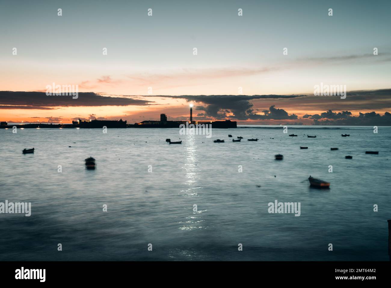 A relaxing view of small boats in the sea on a sunset sky background ...