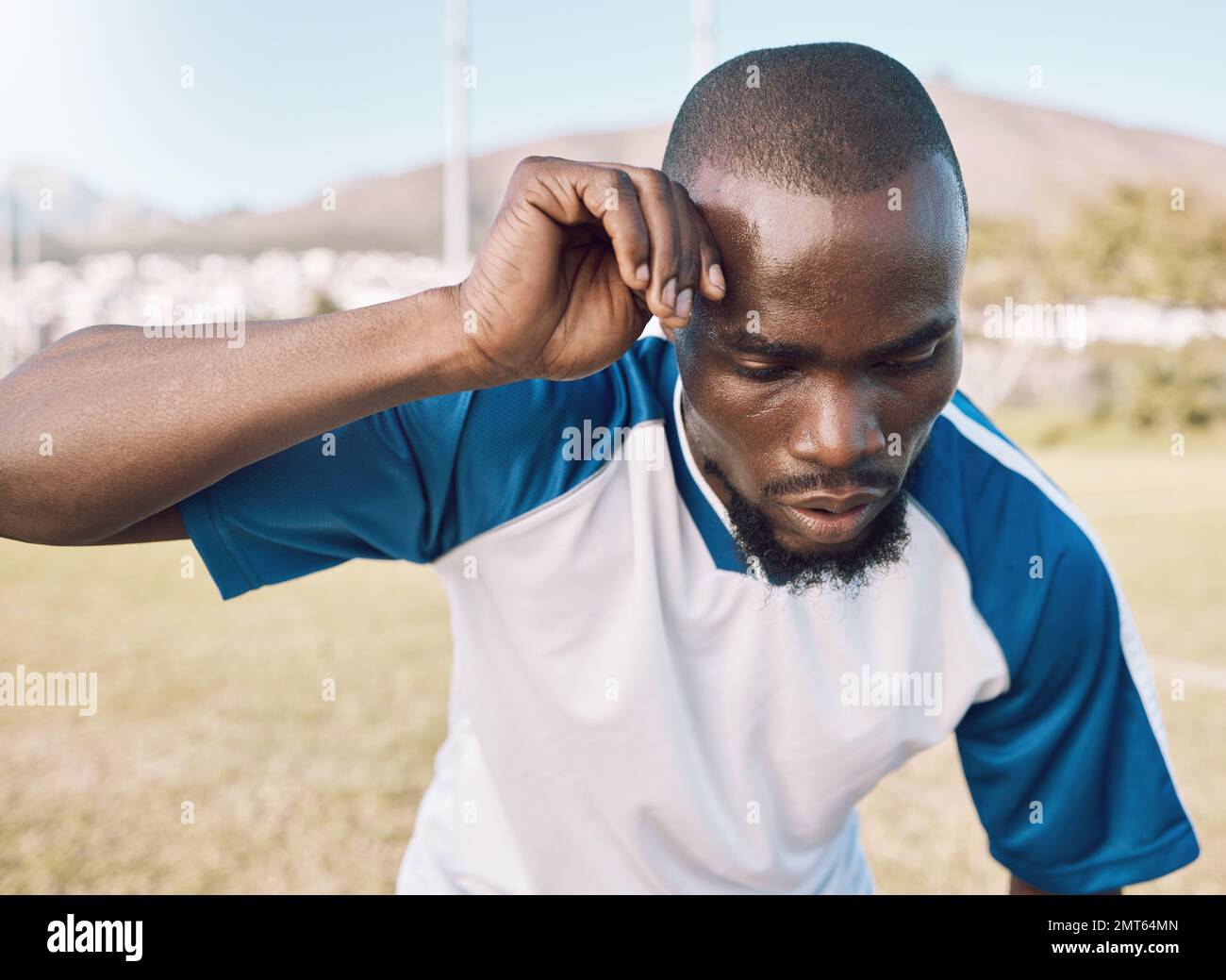 Black man is tired, face and football player on outdoor field, playing ...