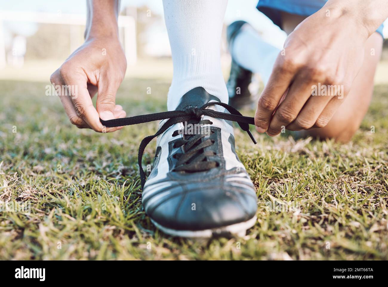 Sports, soccer field and man tie shoes for game, ready for training ...