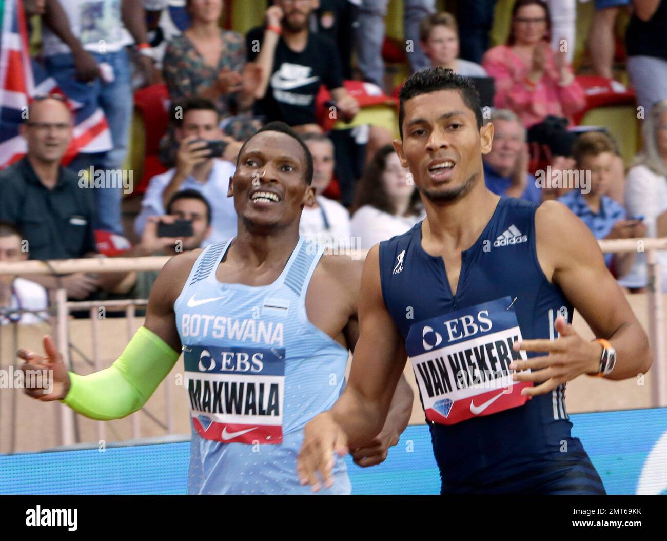 Wayde Van Nierkerk of South Africa, right, crosses the finish line to ...